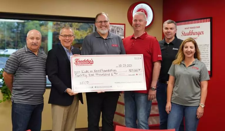 Freddy's presents check to Kids In Need Foundation